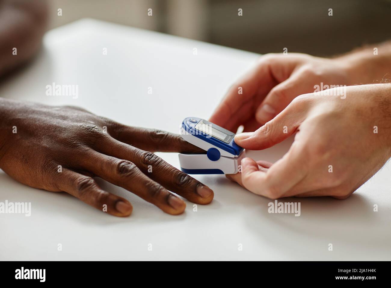 Close-up shot of unrecognizable doctor applying pulse oximeter on Black ...