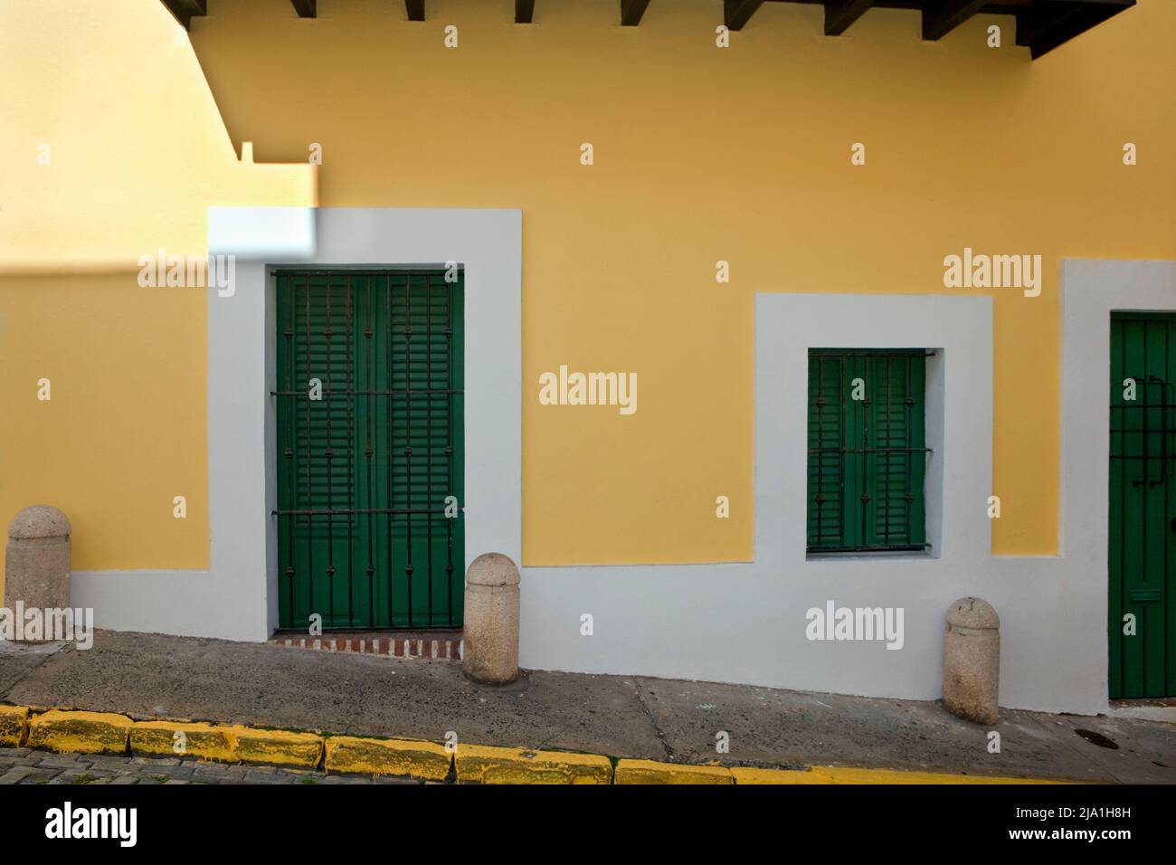 A bright cheerful yellow painted building in Old San Juan, Puerto Rico ...