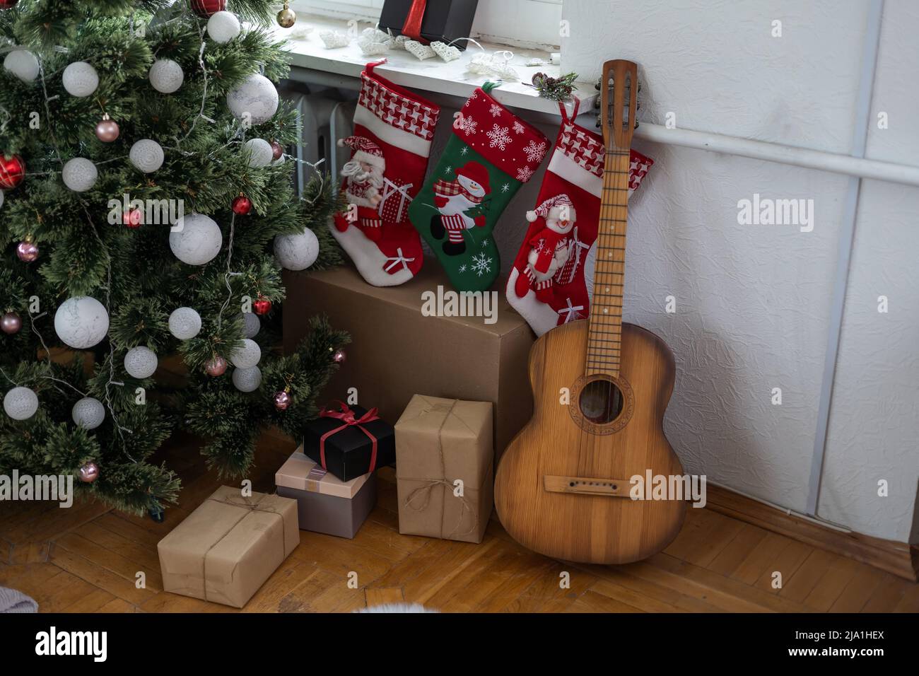 Guitar with decorated Christmas Tree in the background Stock Photo - Alamy