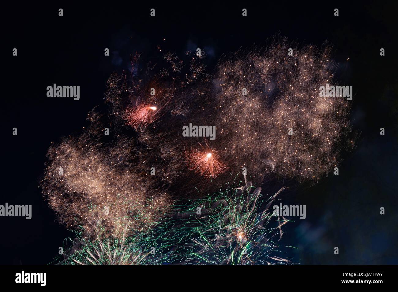 Bright and beautiful sparks of festive fireworks in golden and green ...