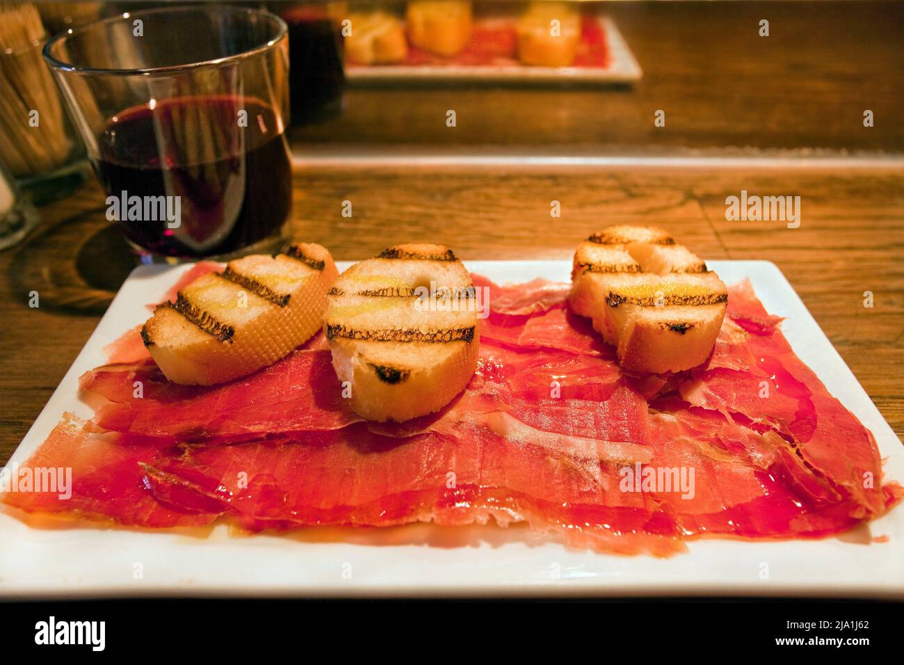 Serrano ham on toast at Spanish tapas bar Stock Photo - Alamy