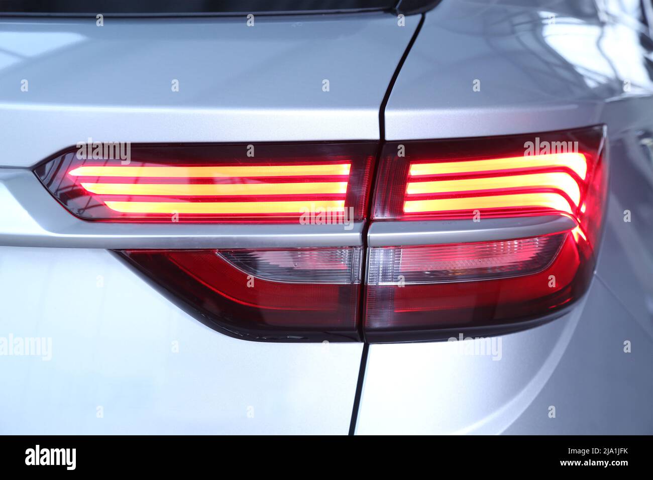 The back of a white expensive crossover car: Close up detail on one of ...