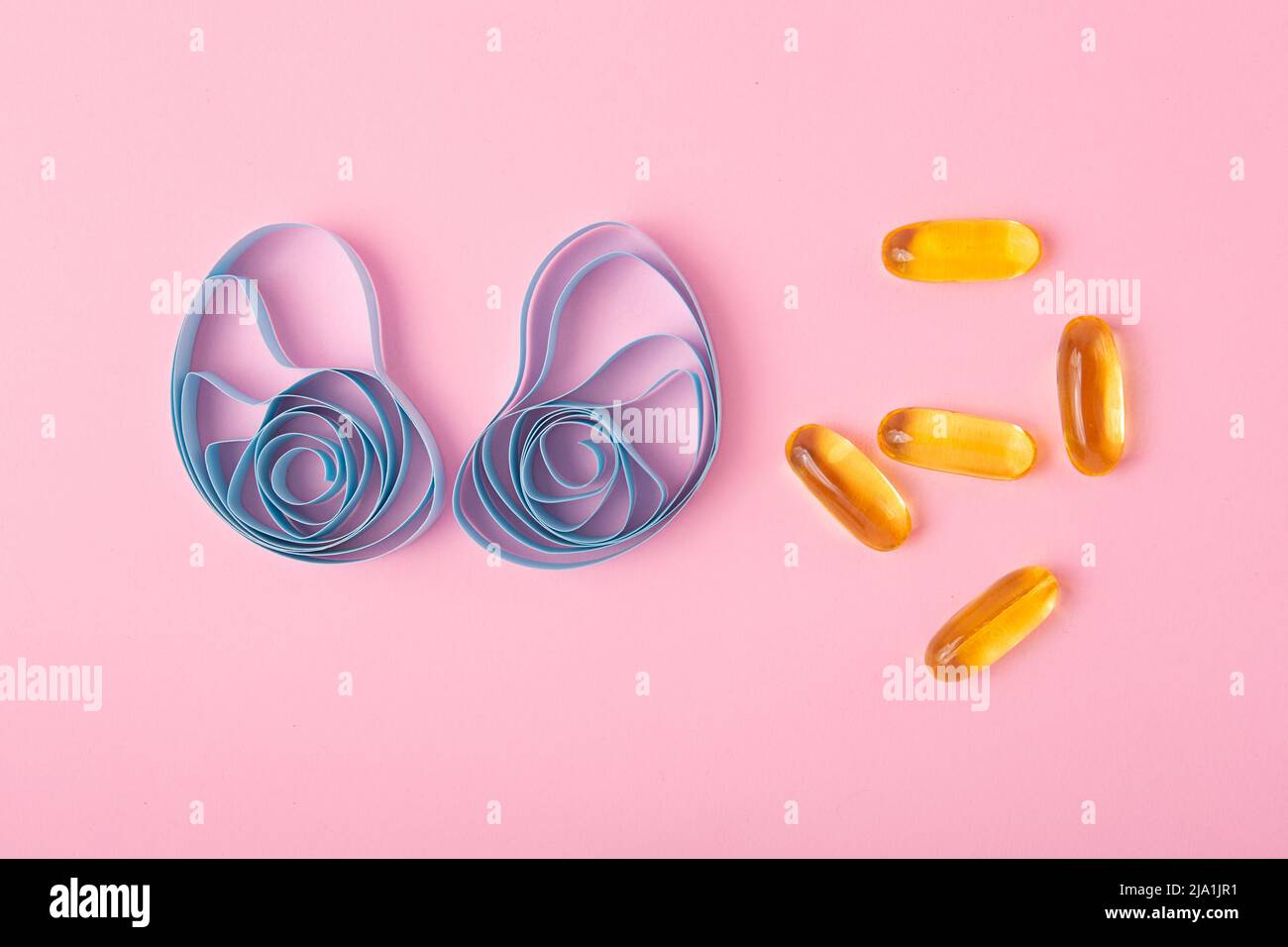 Top view of paper thyroid gland with gelatin capsules and tablets.World ...