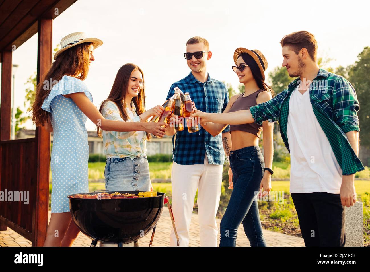 company of friends prepares a barbecue in nature - happy people have ...