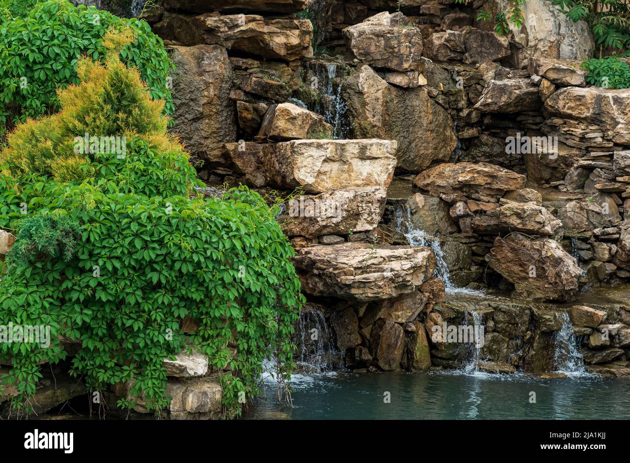 landscape design, a dam with a cascade of waterfalls in the form of ...