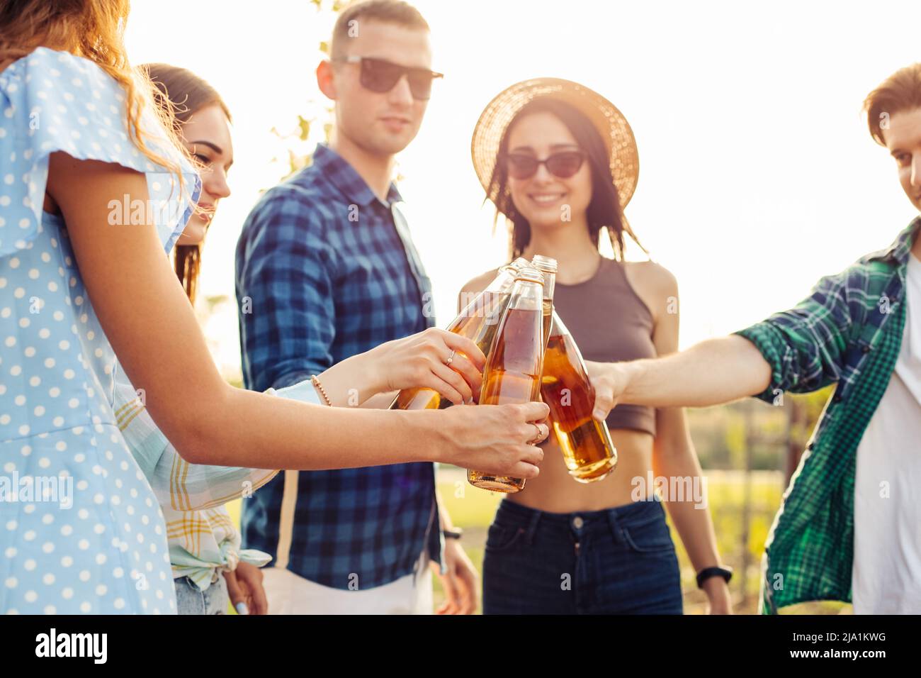 company of friends prepares a barbecue in nature - happy people have ...