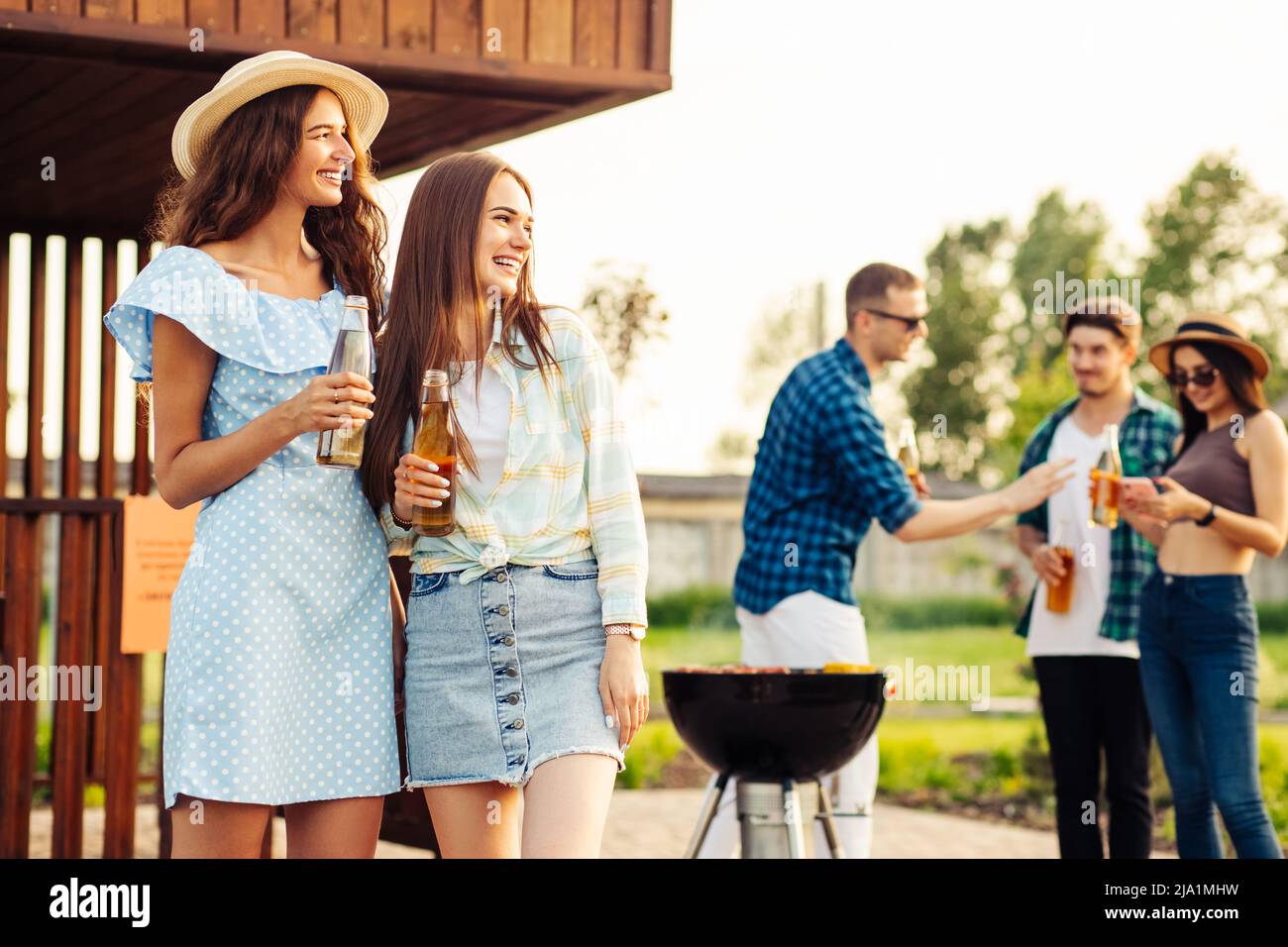 Two women cooking barbeque in hi-res stock photography and images - Alamy