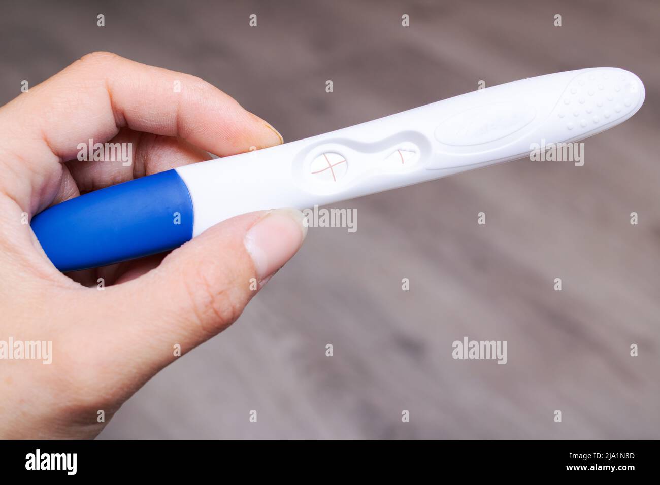 Positive pregnancy test in the arm close up Stock Photo - Alamy