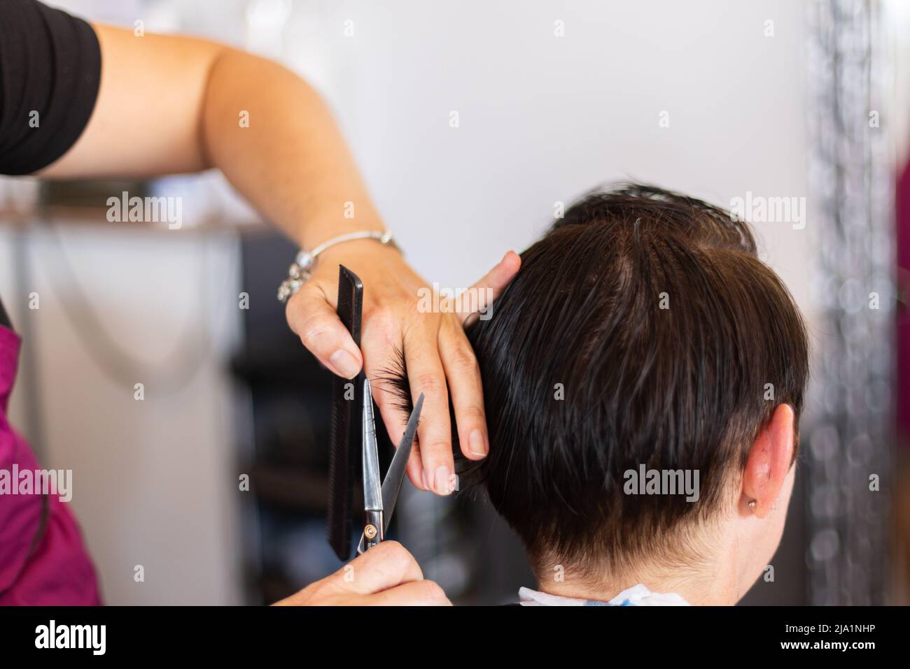 Cutting hair at hairdresser. Treat hair at beauty salon. Closeup Stock ...