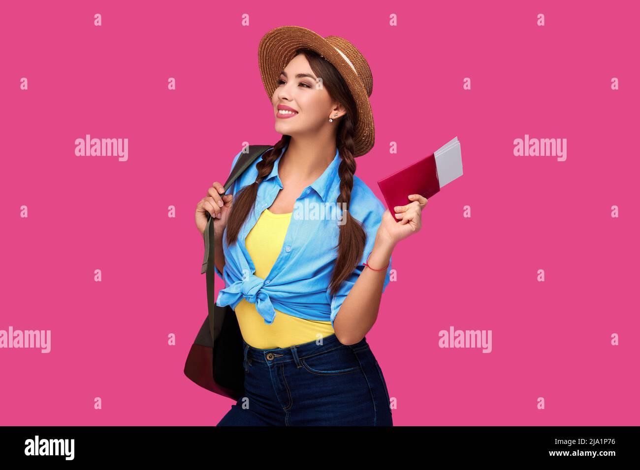 Smiling caucasian woman student holding passport and plane tickets ...