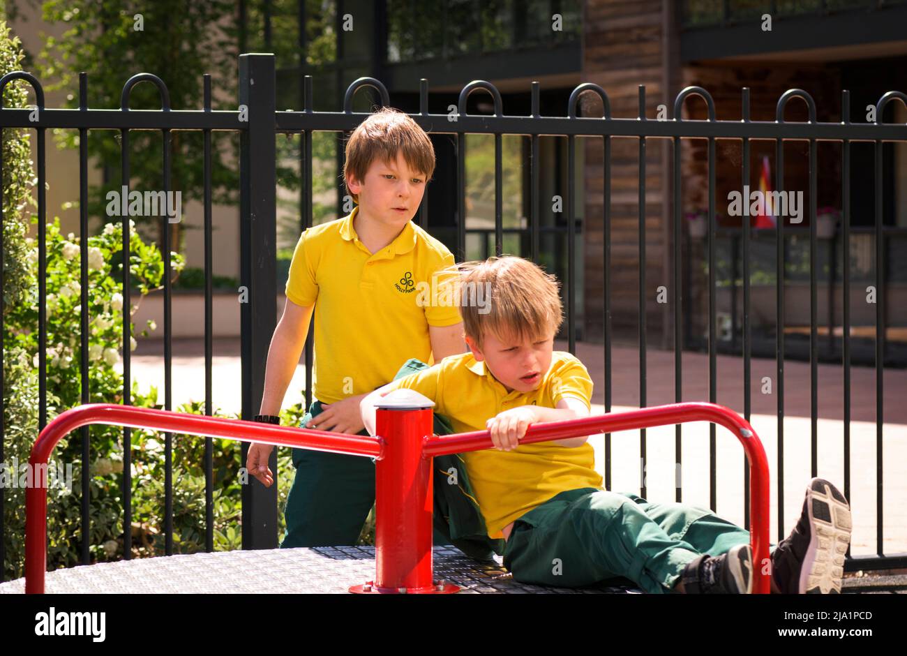Two boy brothers (4-5, 8-9) playing on playground Stock Photo - Alamy