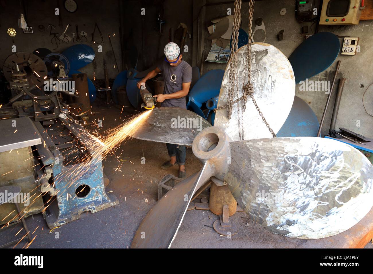 Dhaka, Dhaka, Bangladesh. 26th May, 2022. A man prepares a ship's propeller at a workshop in ...