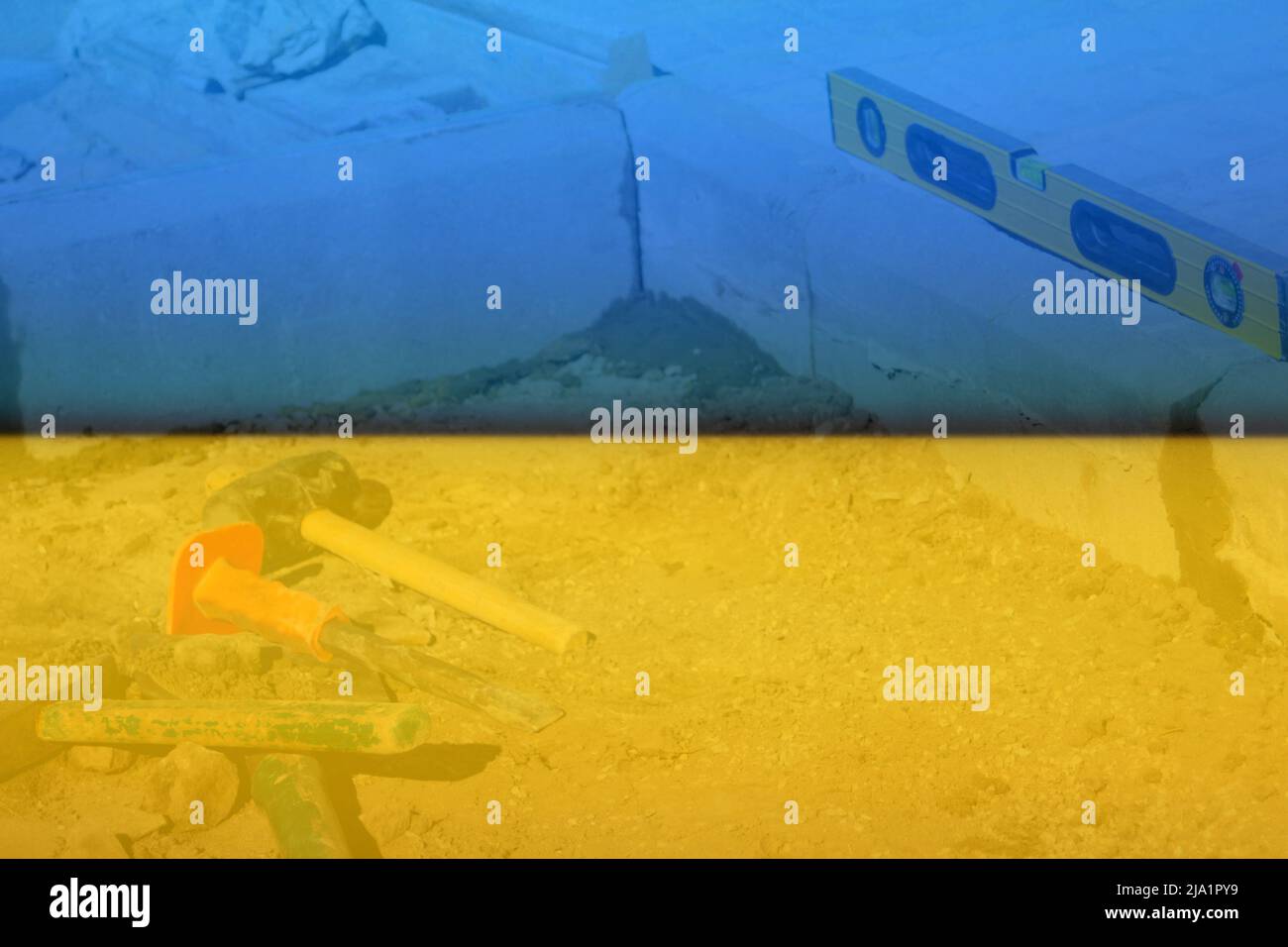 Defocus Paving garden. Yellow spirit level, hammer, mallet, chisel lie ...