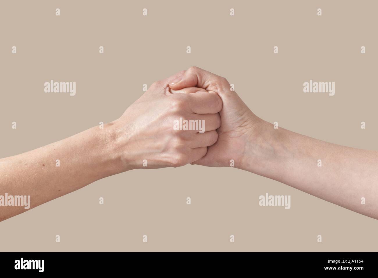 Two female handshake or arm wrestling on white Stock Photo - Alamy