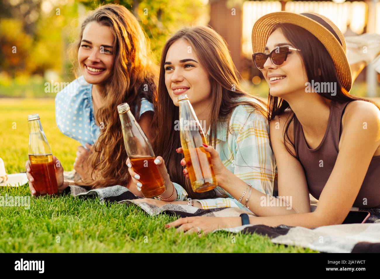 Group of smiling happy beautiful best friends sitting together on a ...