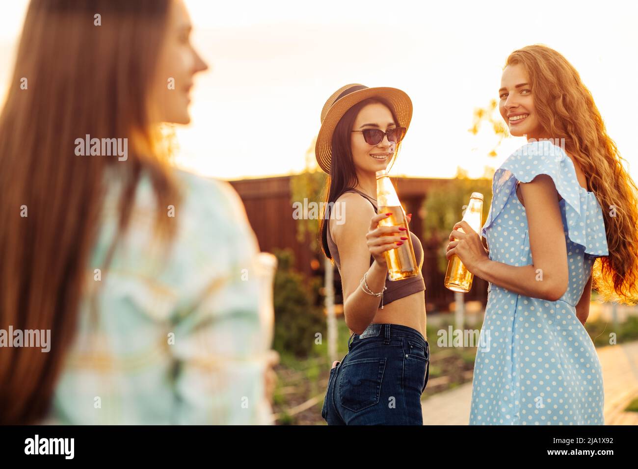 group of friends hang out on the street. They hug each other and walk ...