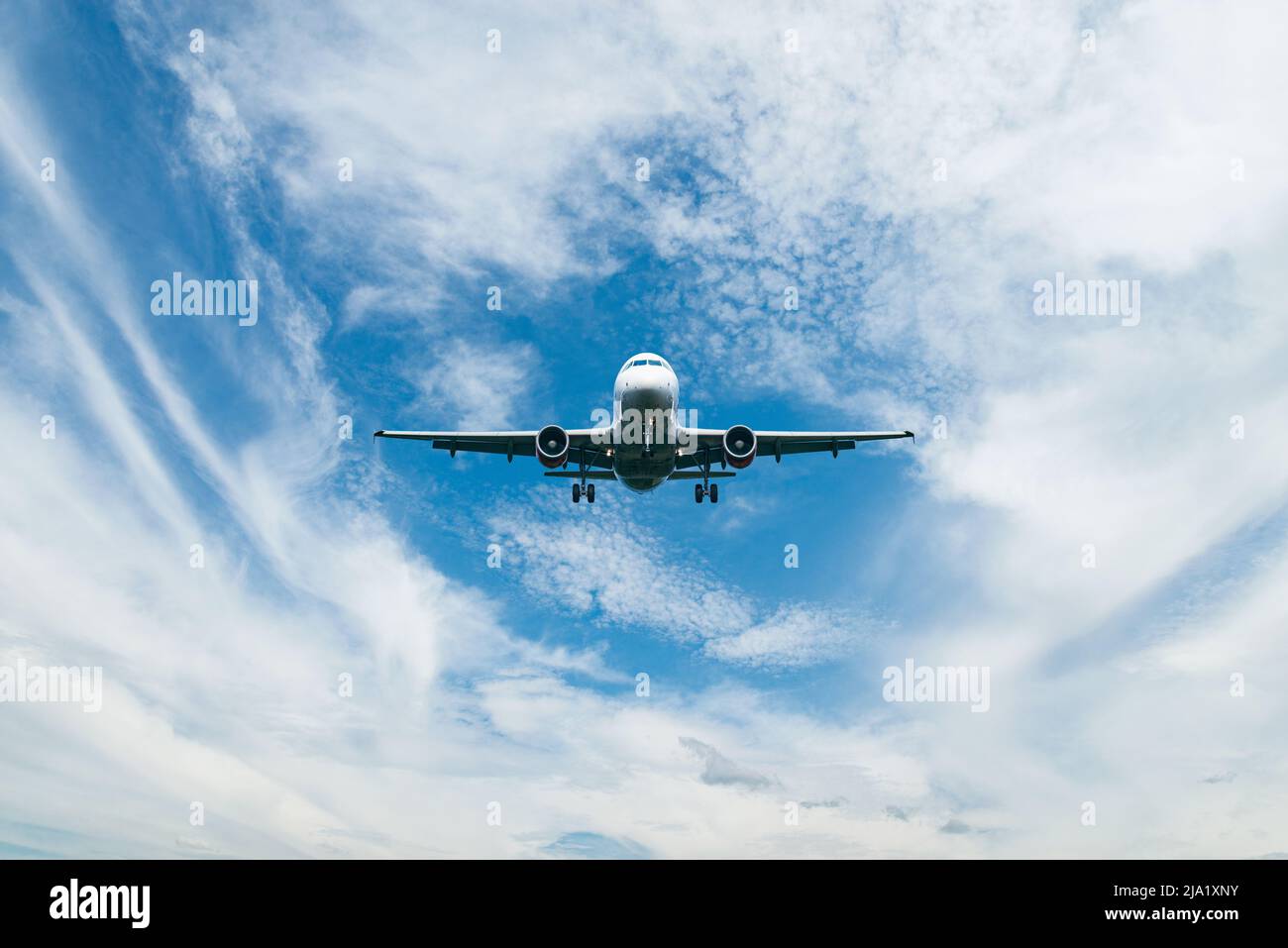 Flight of the passenger plane above the clouds at sunset Stock Photo - Alamy