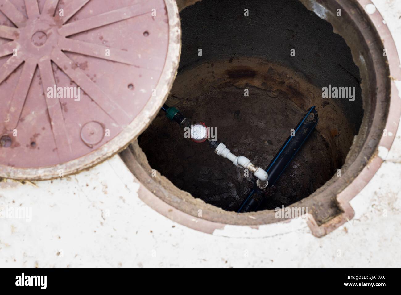 An open water well with a water metering unit carried into the house ...