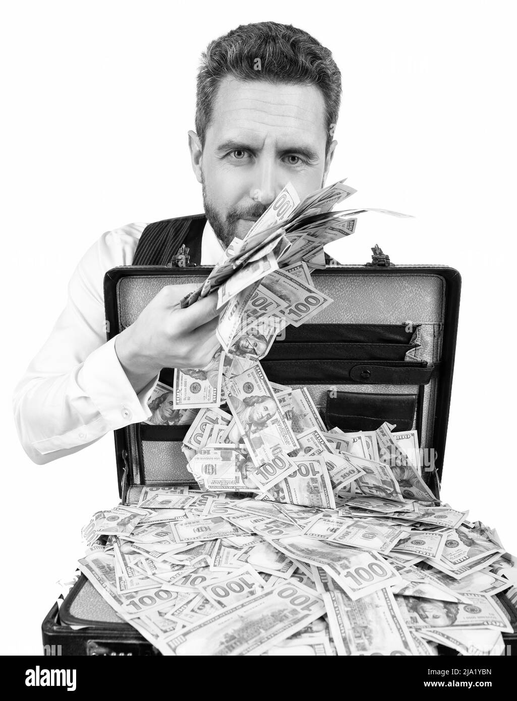 rich millionaire holding case full of dollar cash isolated on white ...