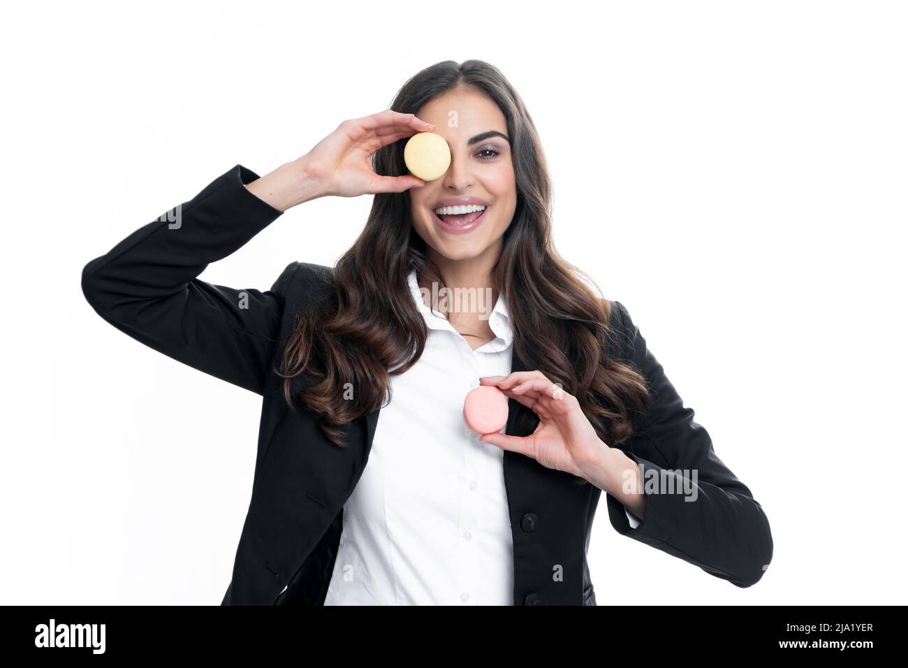 Young woman eating delicious macaroon on white background. Girl eat the ...