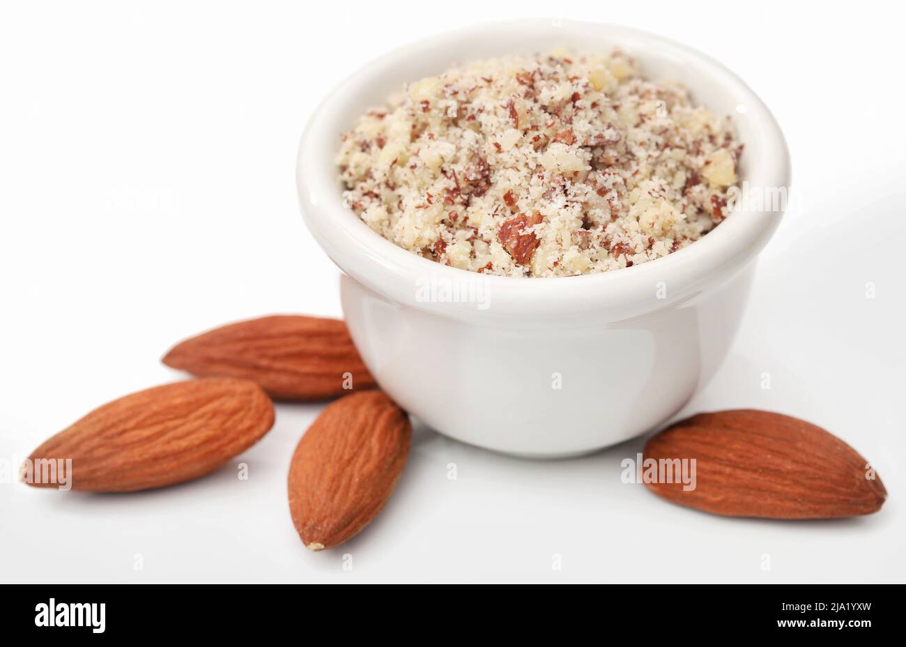 Crushed with peeled almond over white background Stock Photo - Alamy