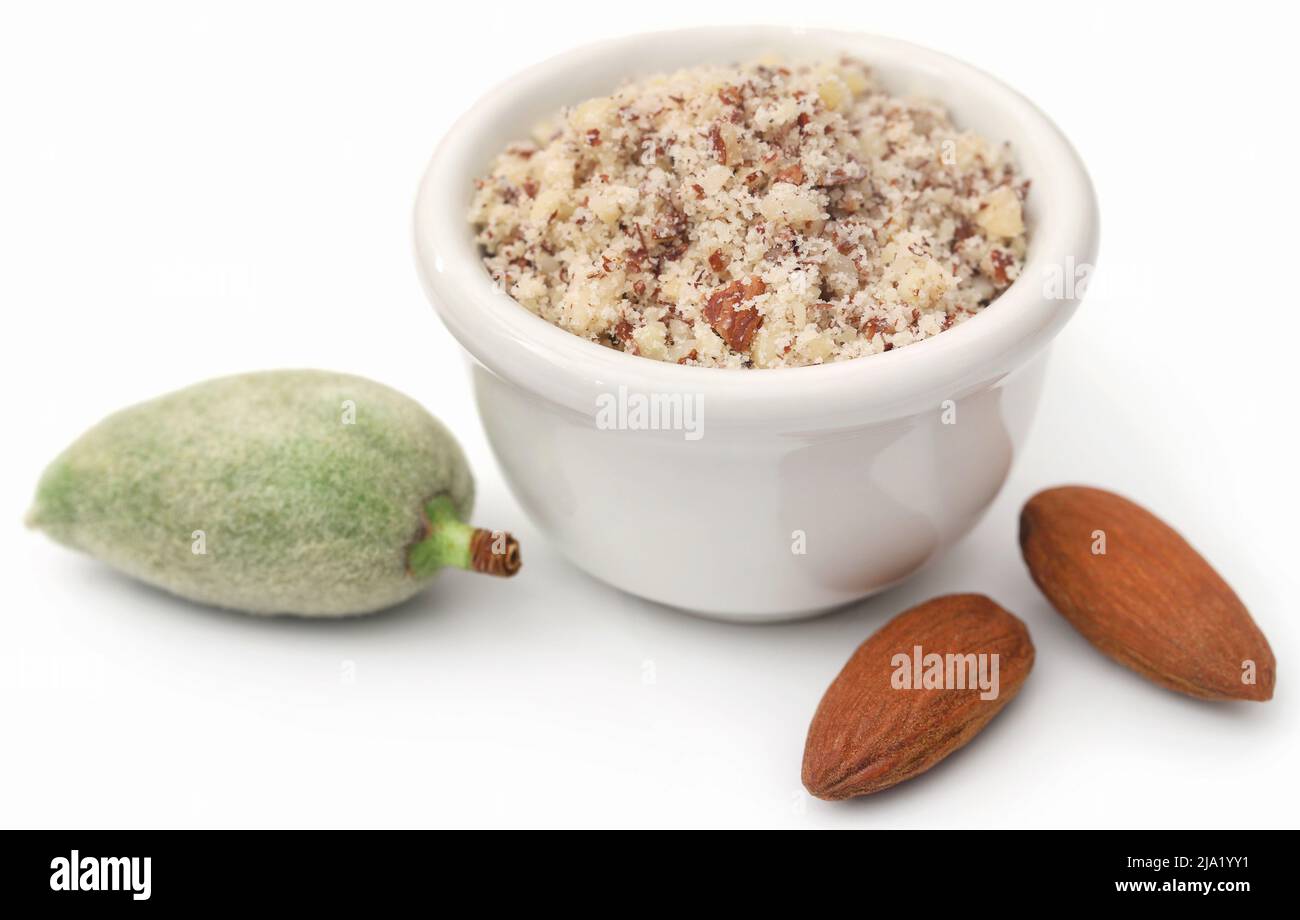 Crushed with green and peeled almond over white background Stock Photo ...