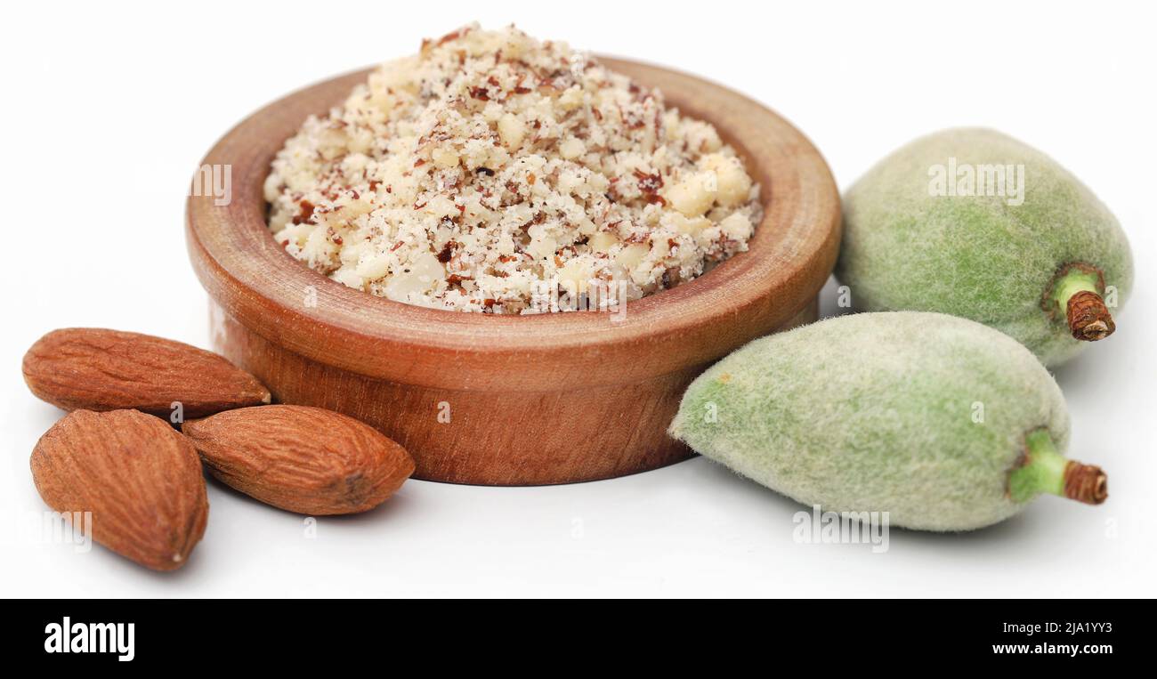 Crushed with green and peeled almond over white background Stock Photo ...