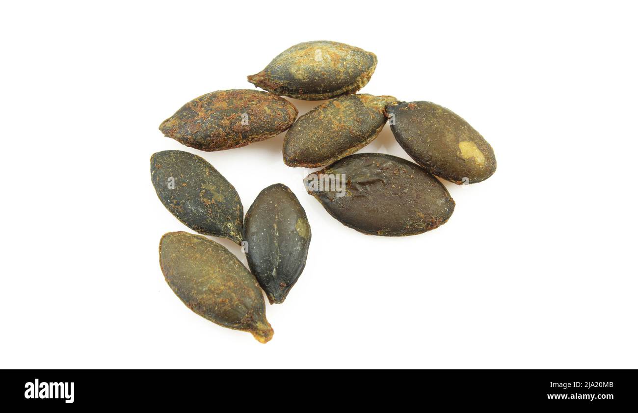 Few unshelled and roasted pumpkin seeds isolated on white background ...