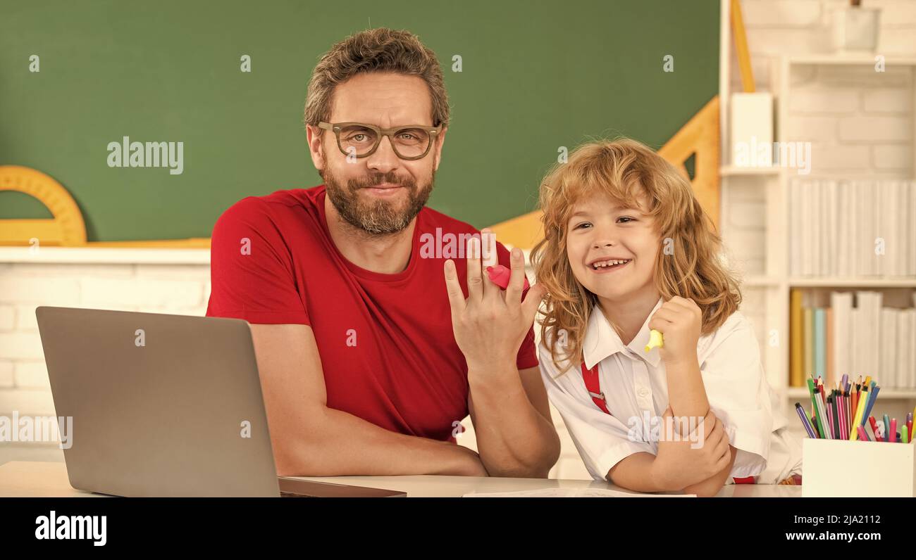daddy and son study in classroom with laptop, online education Stock ...