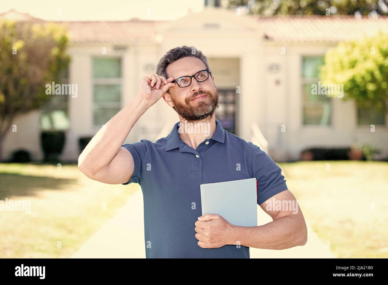 mature teacher nerd looking smart in eyeglasses with paper sheet ...