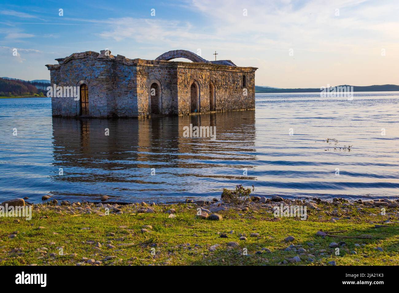 Sunset sky over the sunken church of St.Ivan Rilski at Zhrebchevo Dam ...