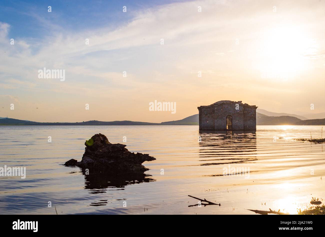 Sunset sky over the sunken church of St.Ivan Rilski at Zhrebchevo Dam ...
