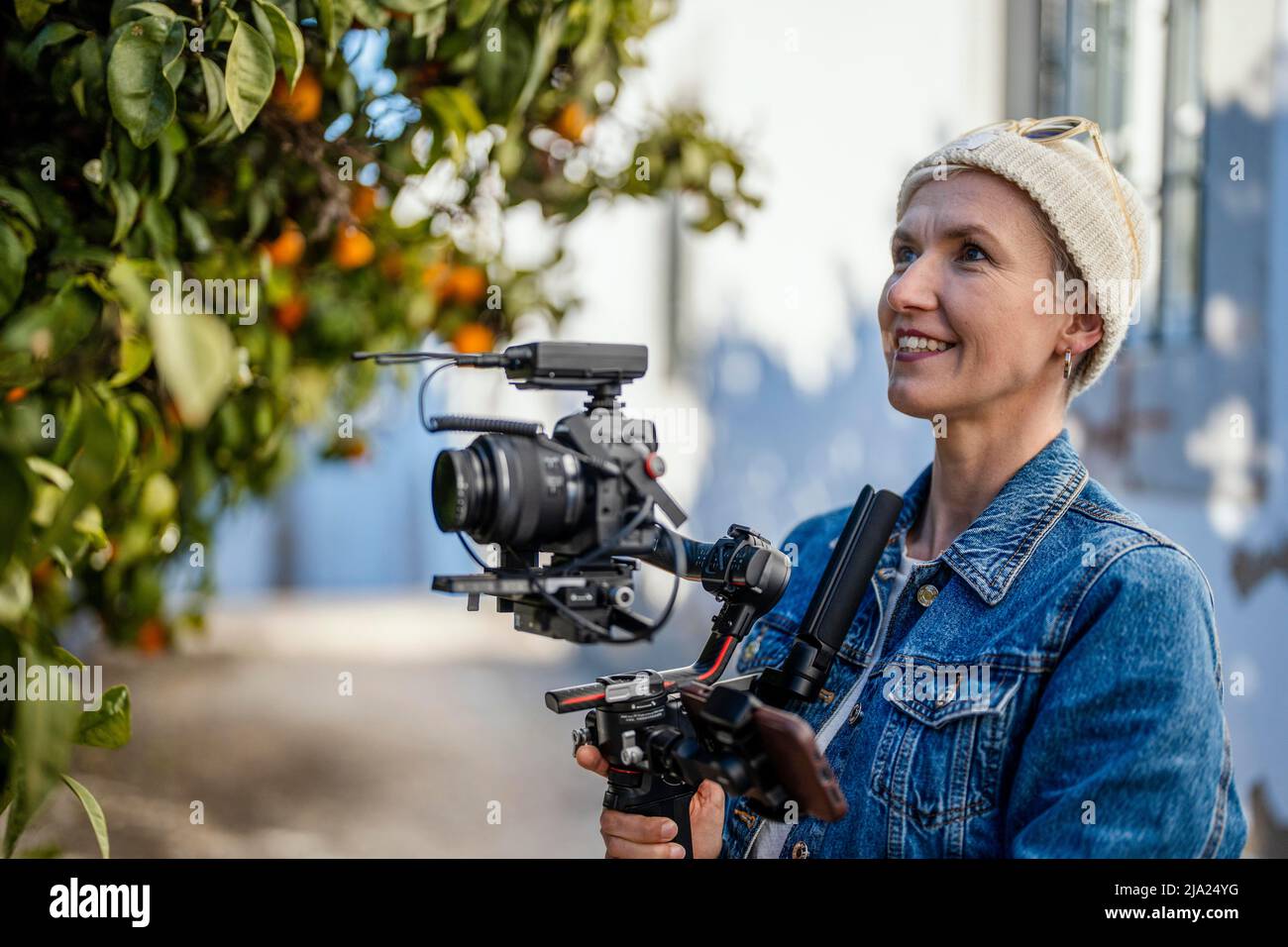 Camera operator with movie setup including a gimbal, video transmitter ...