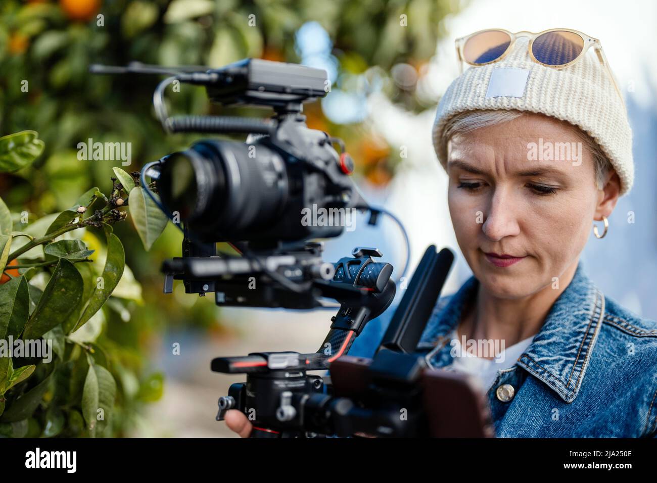 Camera operator with movie setup including a gimbal, video transmitter ...