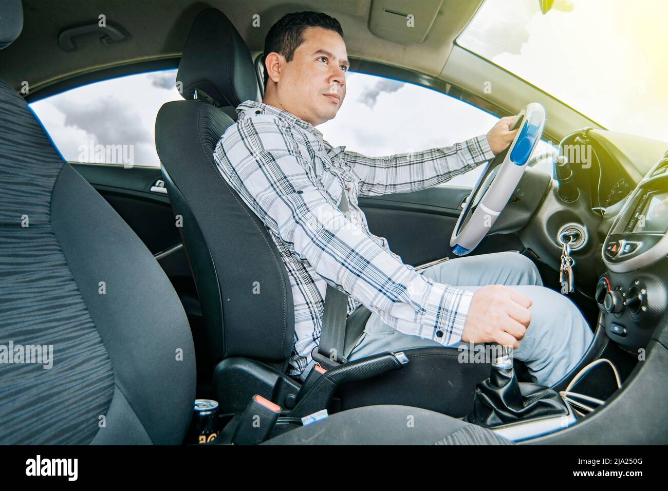 A happy man driving a car, Side view of a man driving a car, interior ...