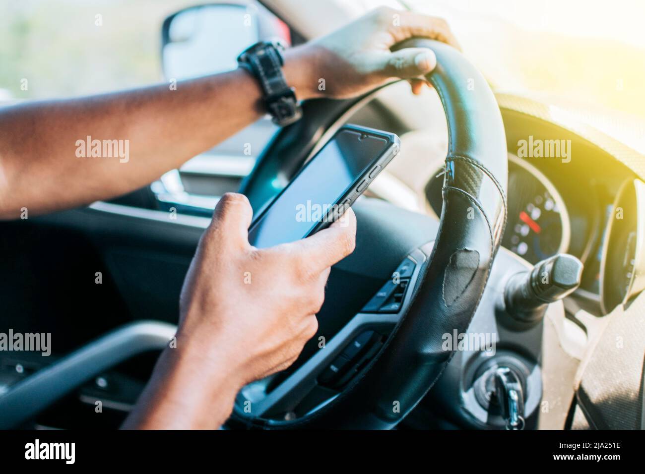 Person in his car using cell phone, Close up of driver hands using his ...