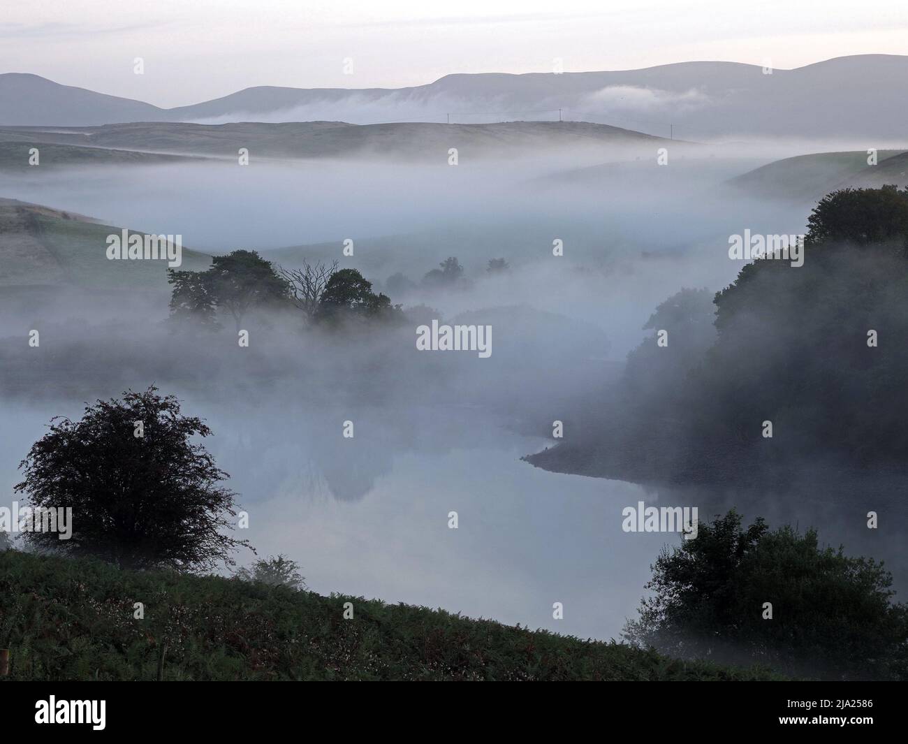 dramatic inversion clouds flowing through valleys in upland northern ...