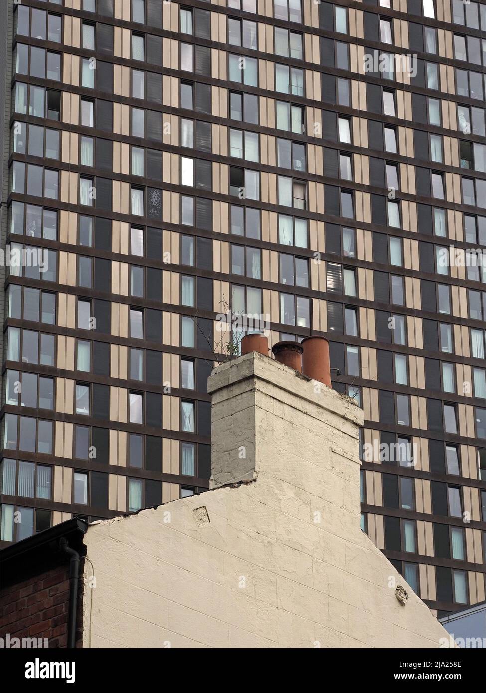 old-fashioned building with chimney-stack juxtaposed against modern ...