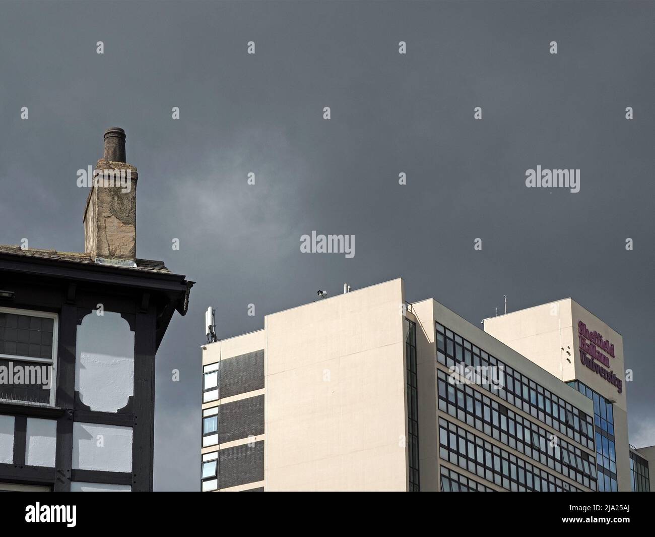 old-fashioned building with chimney-stack juxtaposed against modern ...