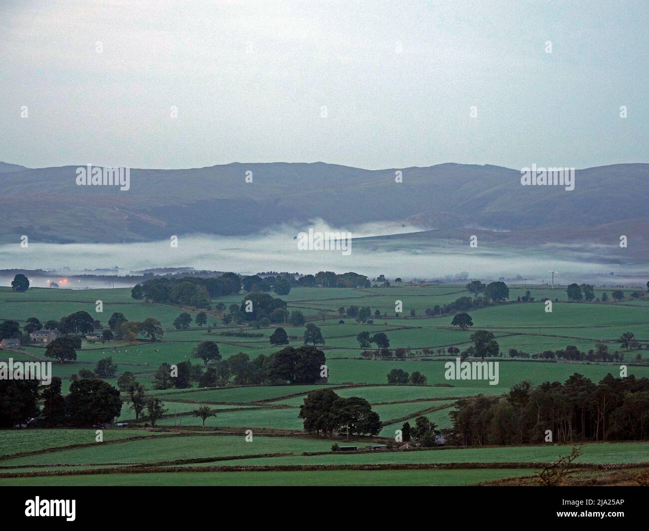 dramatic inversion clouds flowing through valleys in upland northern ...