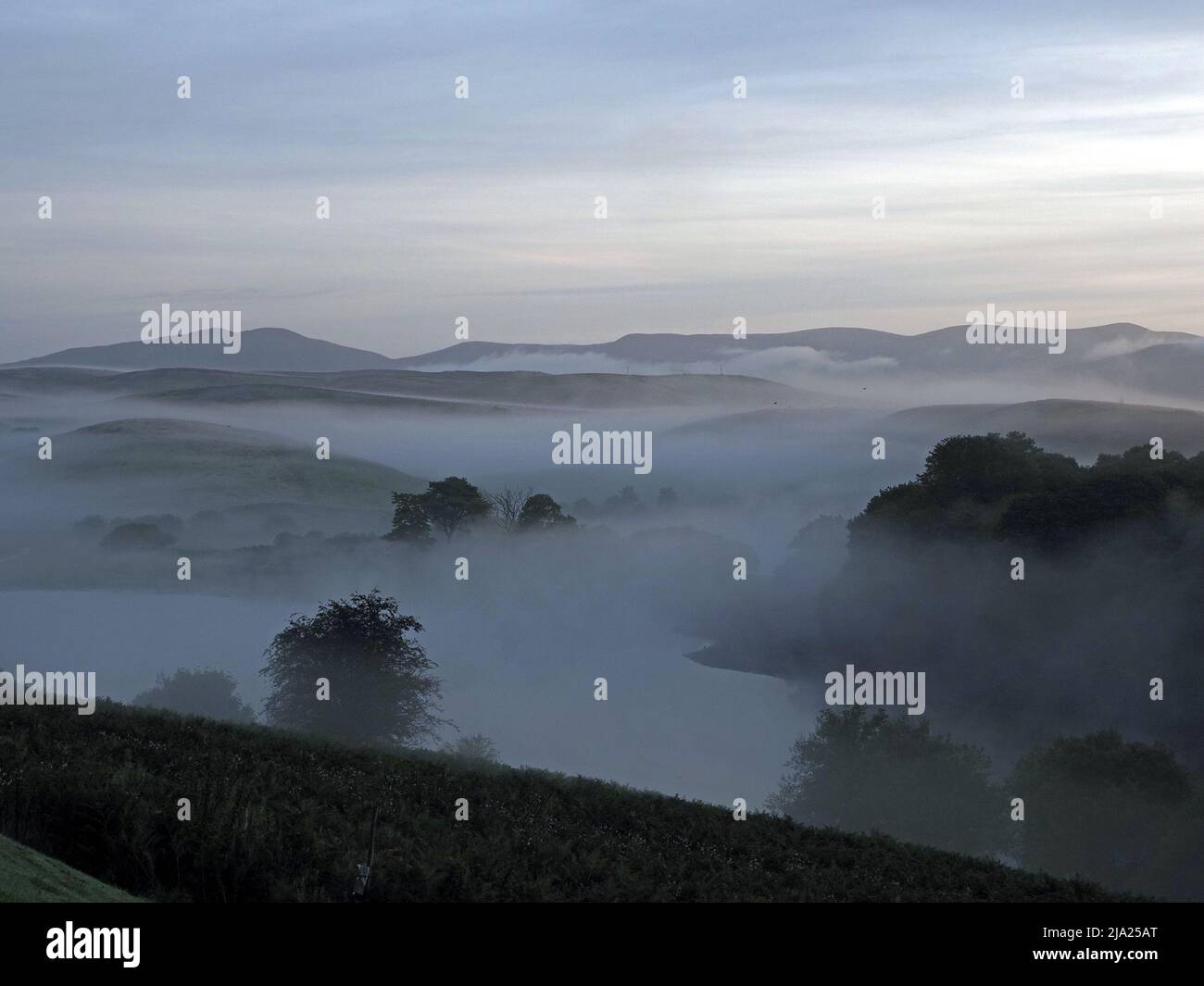 dramatic inversion clouds flowing through valleys in upland northern ...
