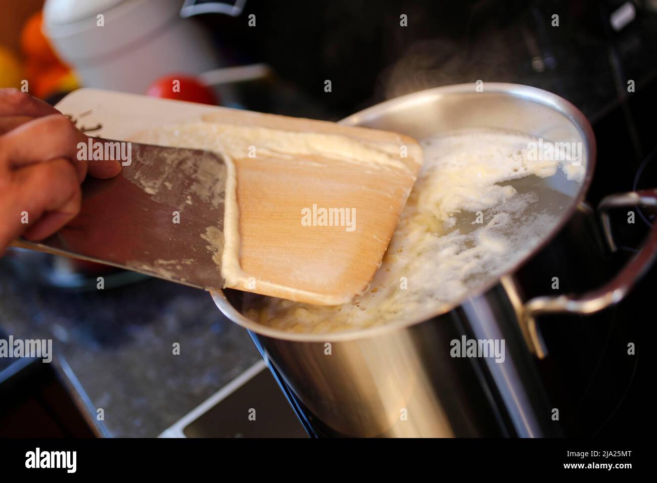Swabian cuisine, preparing spaetzle for cheese spatulas, hand-scraped ...