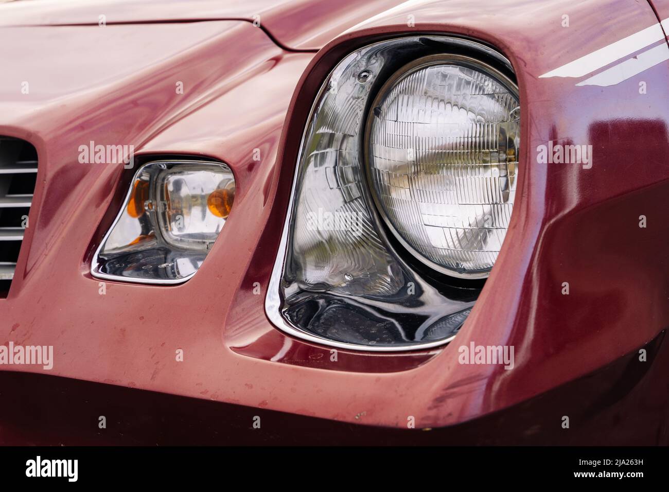 front headlight is a close-up of an old powerful classic American car ...