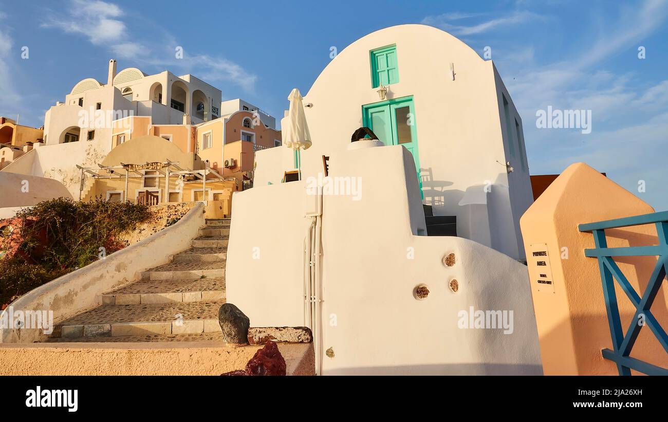 Evening light, barrel-shaped typical Cycladic houses, stairs, blue sky ...