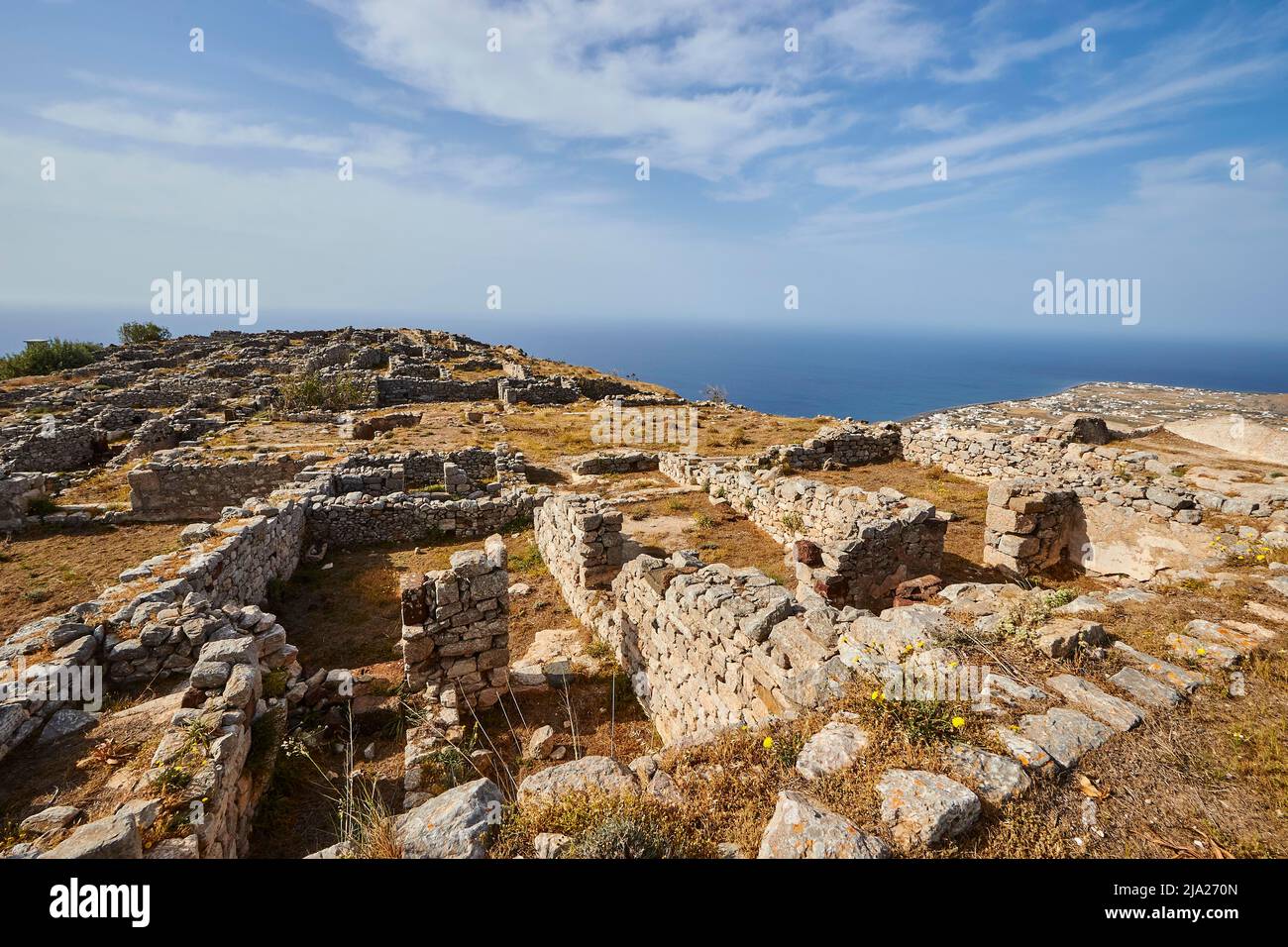 Ancient walls, building remains, sea, blue sky with clouds, mountain ...