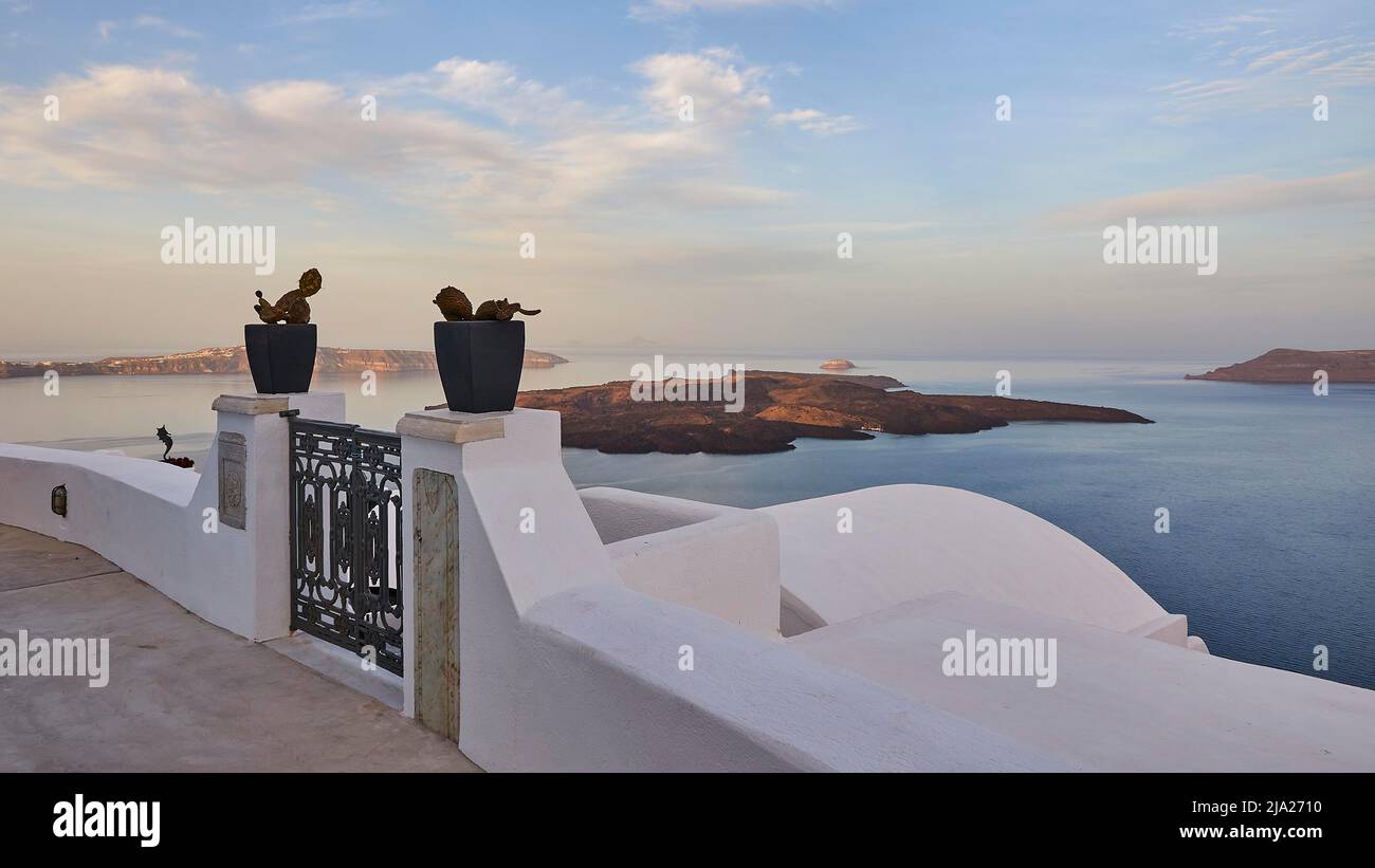 Morning light, blue sky, clouds, white wall, flower pots, volcanic ...