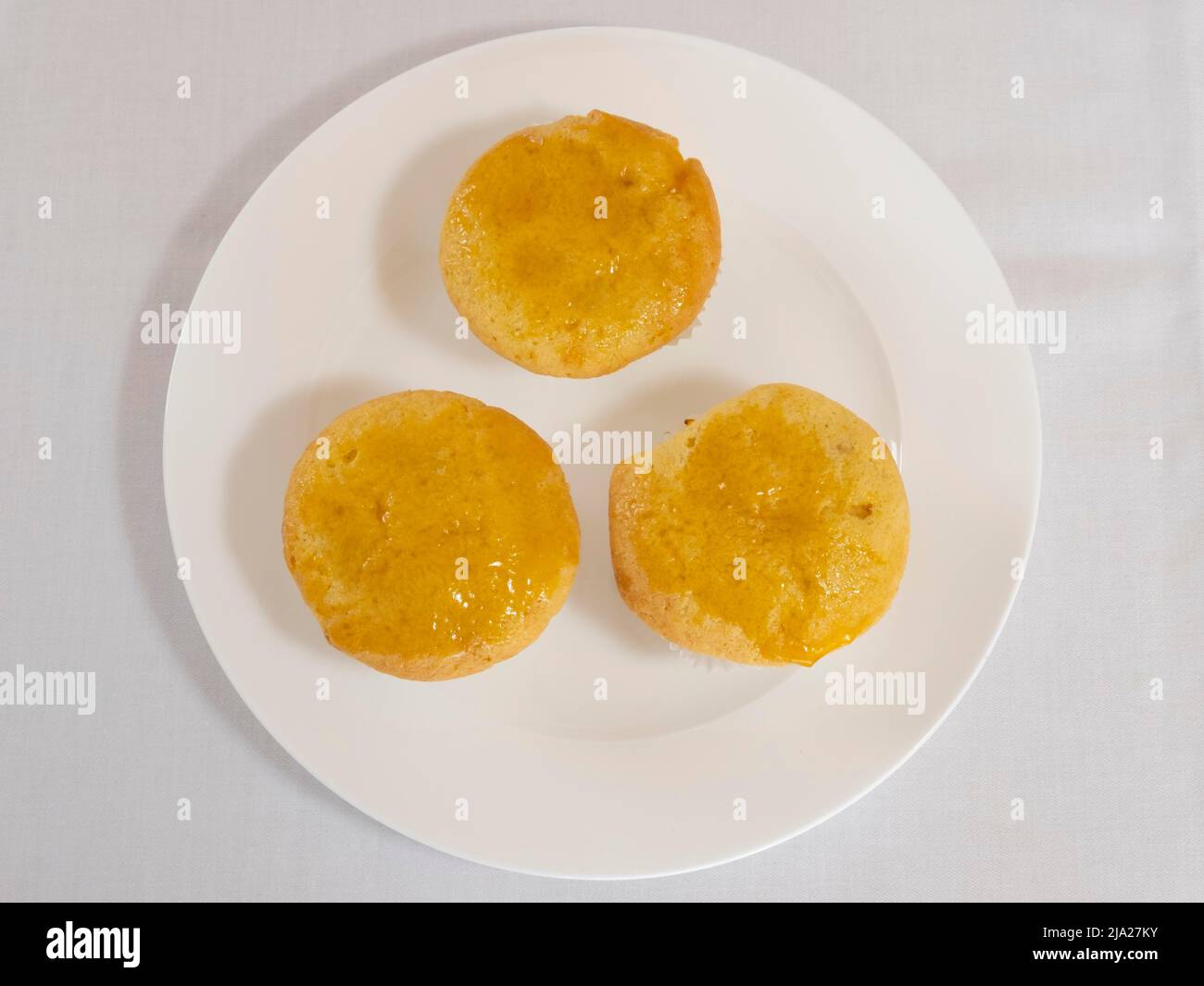Three muffin on a cake plate Stock Photo - Alamy