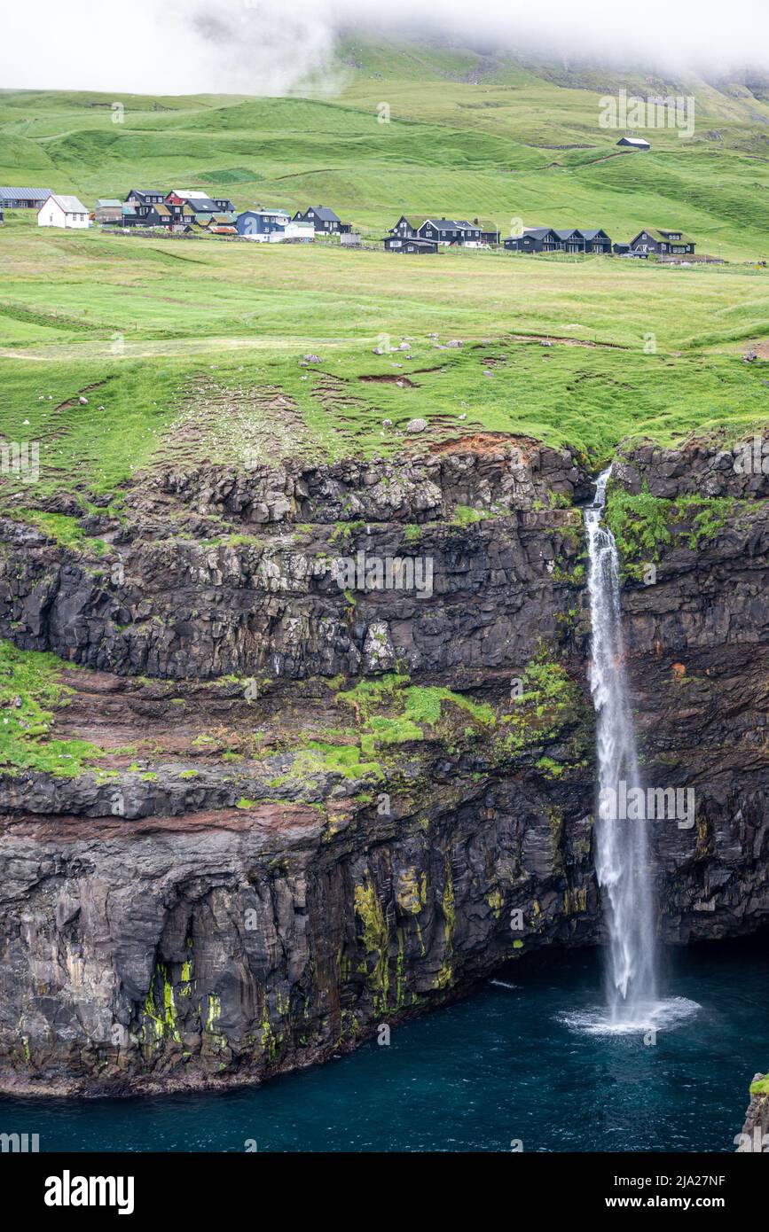 Mulafossur waterfall into the ocean behind Gásadalur Village, Vágar ...
