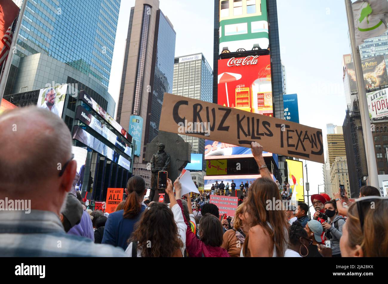 March participants are seen holding signs at Times Square, New York ...