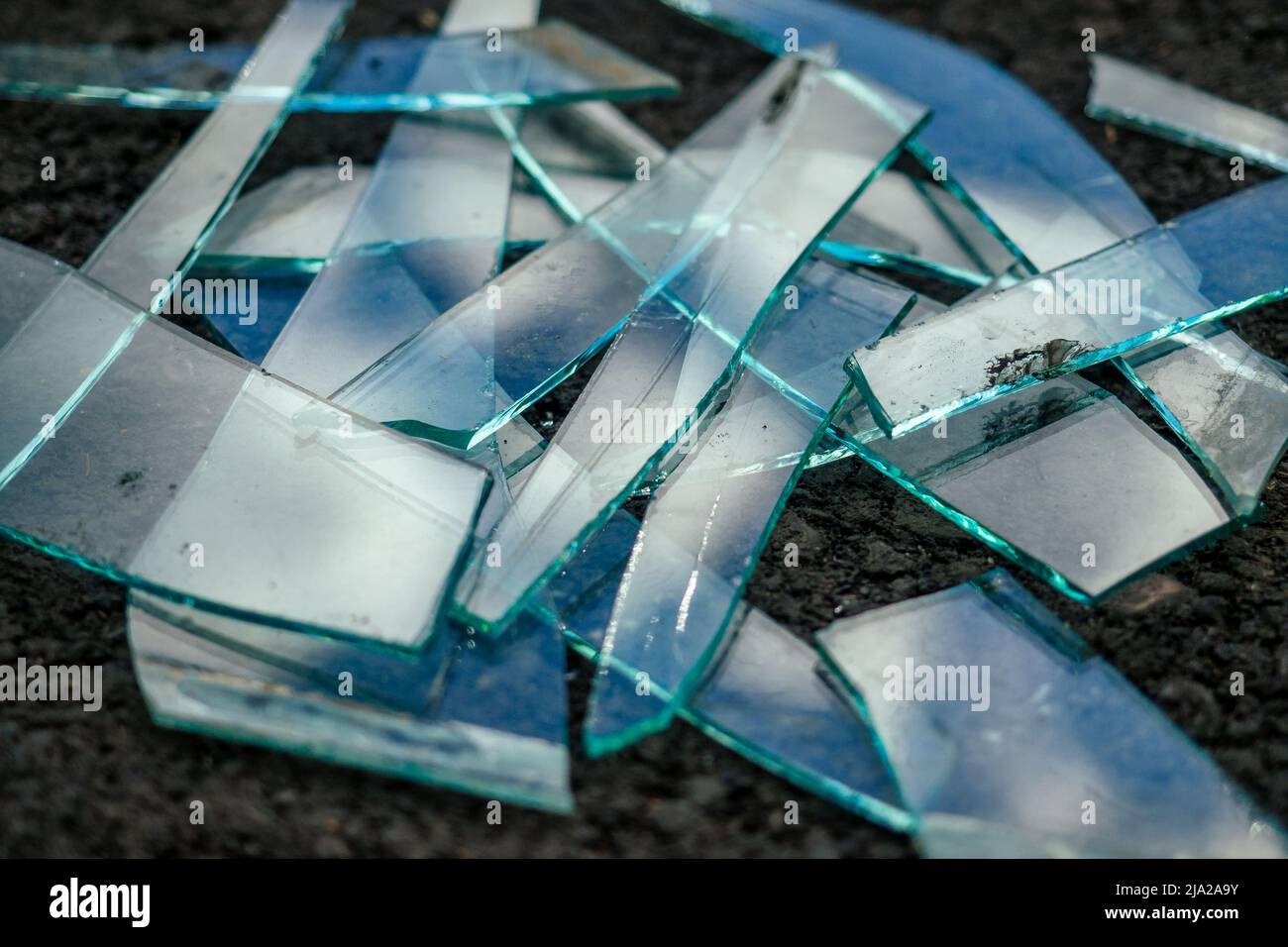 a pile of broken glass lying on the asphalt Stock Photo - Alamy